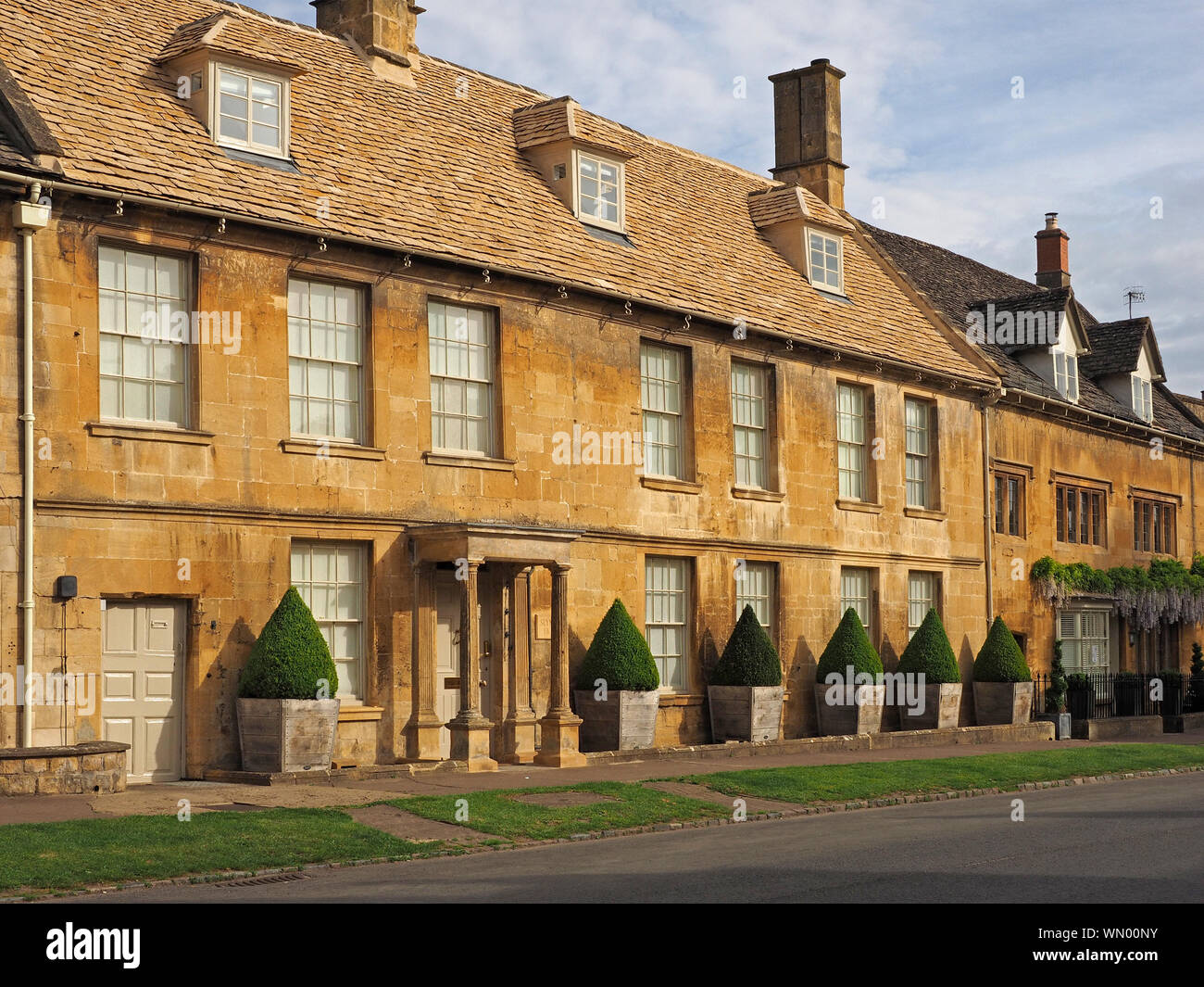 typical local golden honey-coloured Cotswold stone buildings with ...