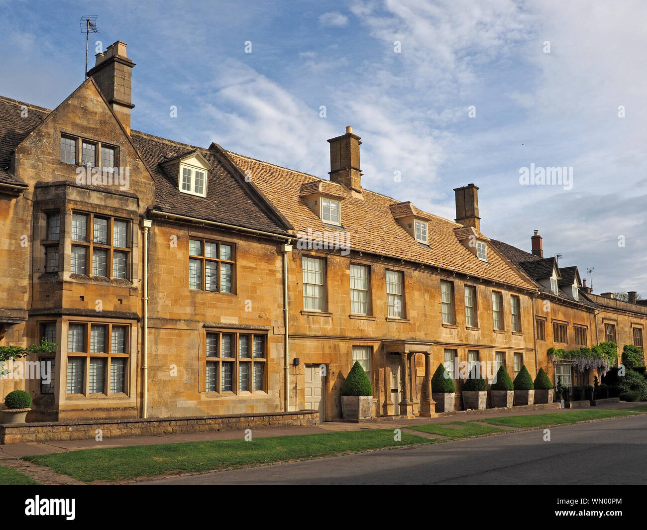 typical local golden honey-coloured Cotswold stone buildings with ...