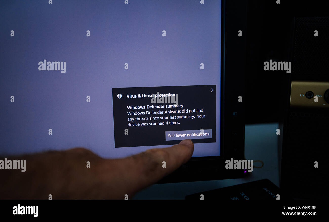Paris, France - May 18, 2019: man hand pointing to Virus and Threat ...