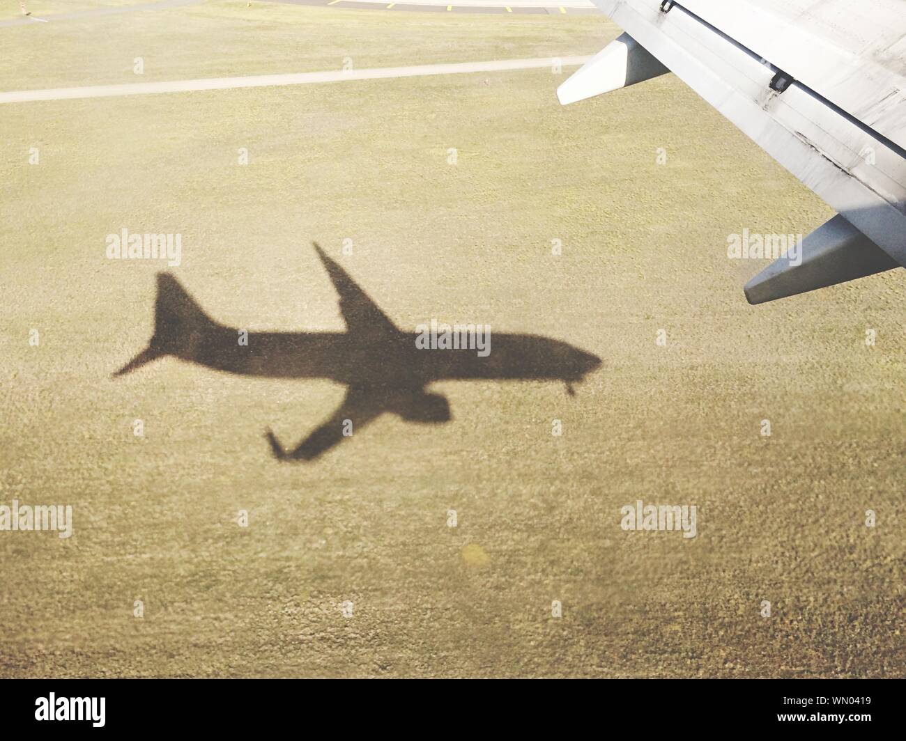 Airplane shadow on runway hi-res stock photography and images - Alamy