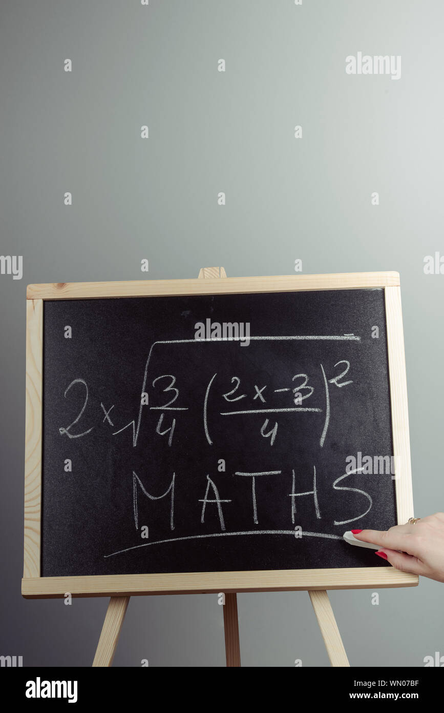 Math exercise written on the chalkboard. Gray background Stock Photo ...