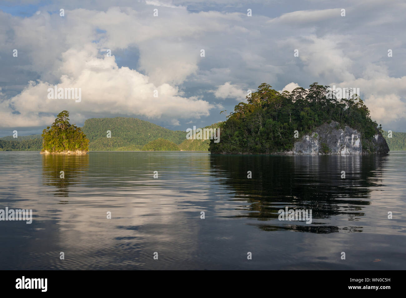Beautiful limestone islands rise from the tranquil seascape amid the ...