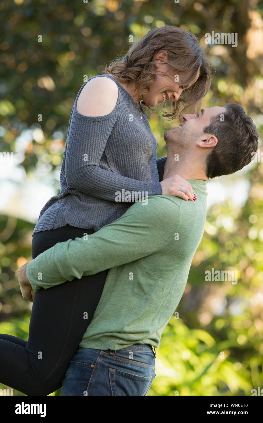 Man lifting young woman Stock Photo - Alamy