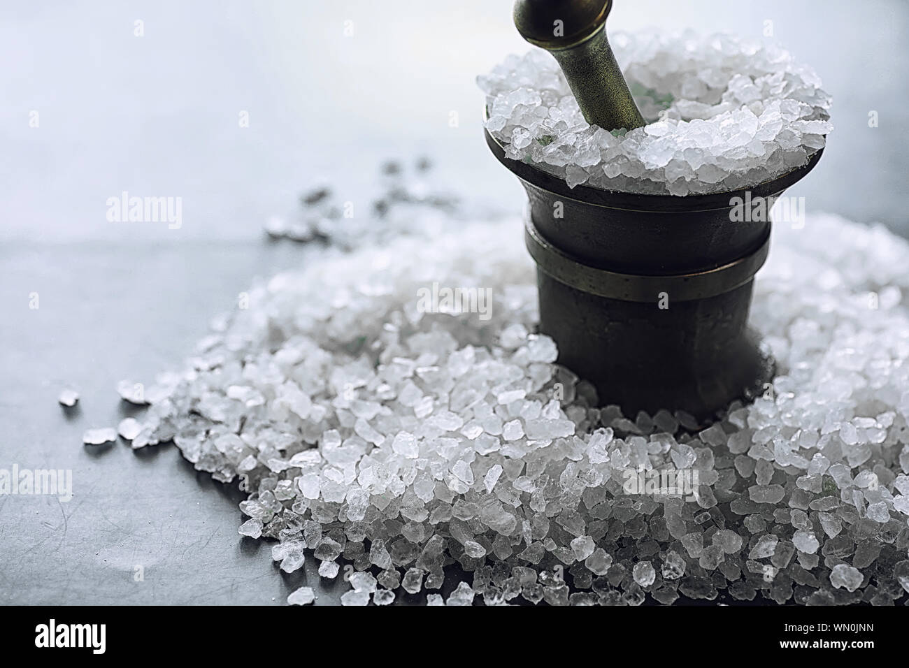 Large sea salt. Spice. Mortar and pestle for grinding Stock Photo - Alamy