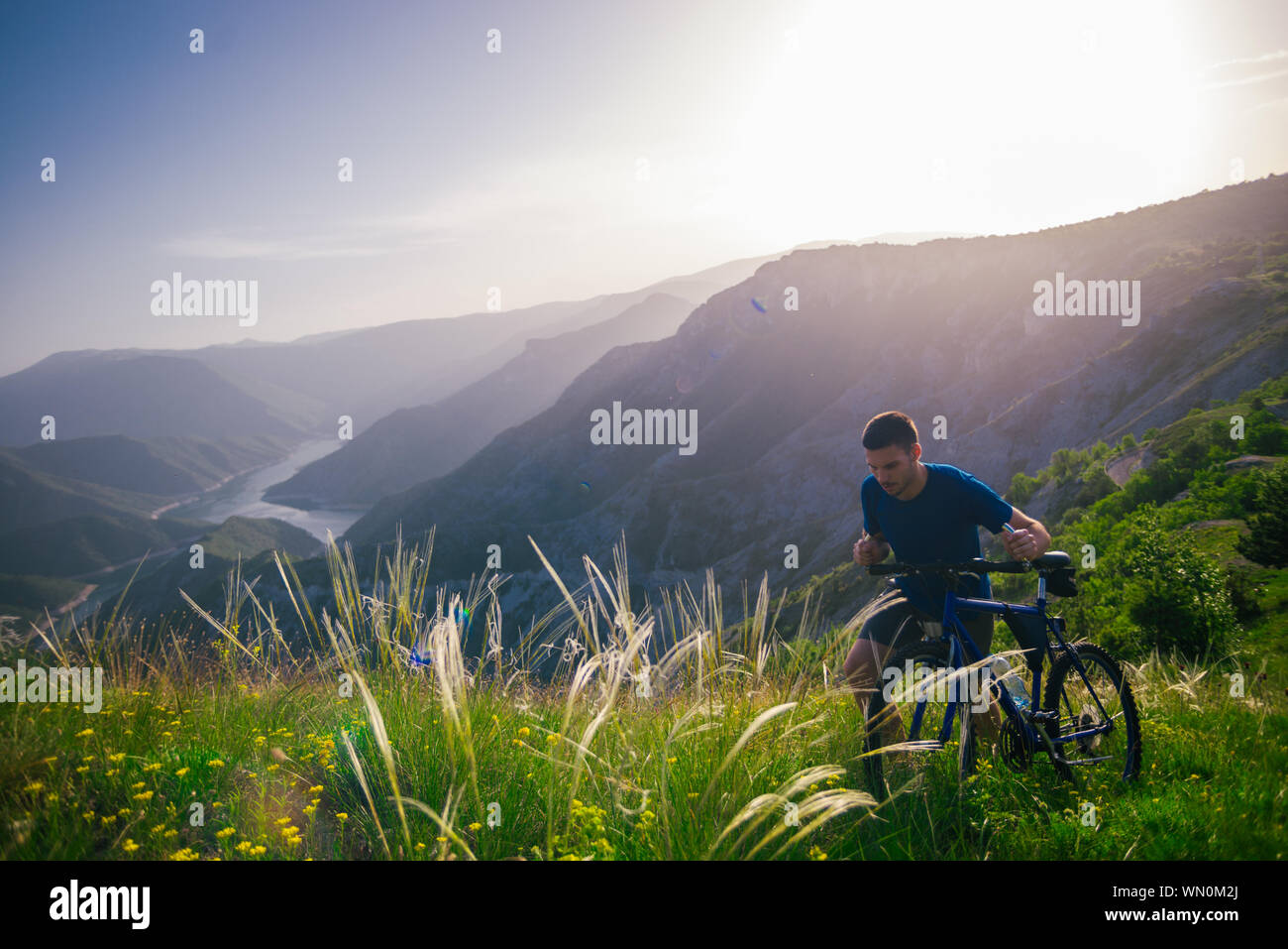 Downhill rider pushing bike hi-res stock photography and images - Alamy