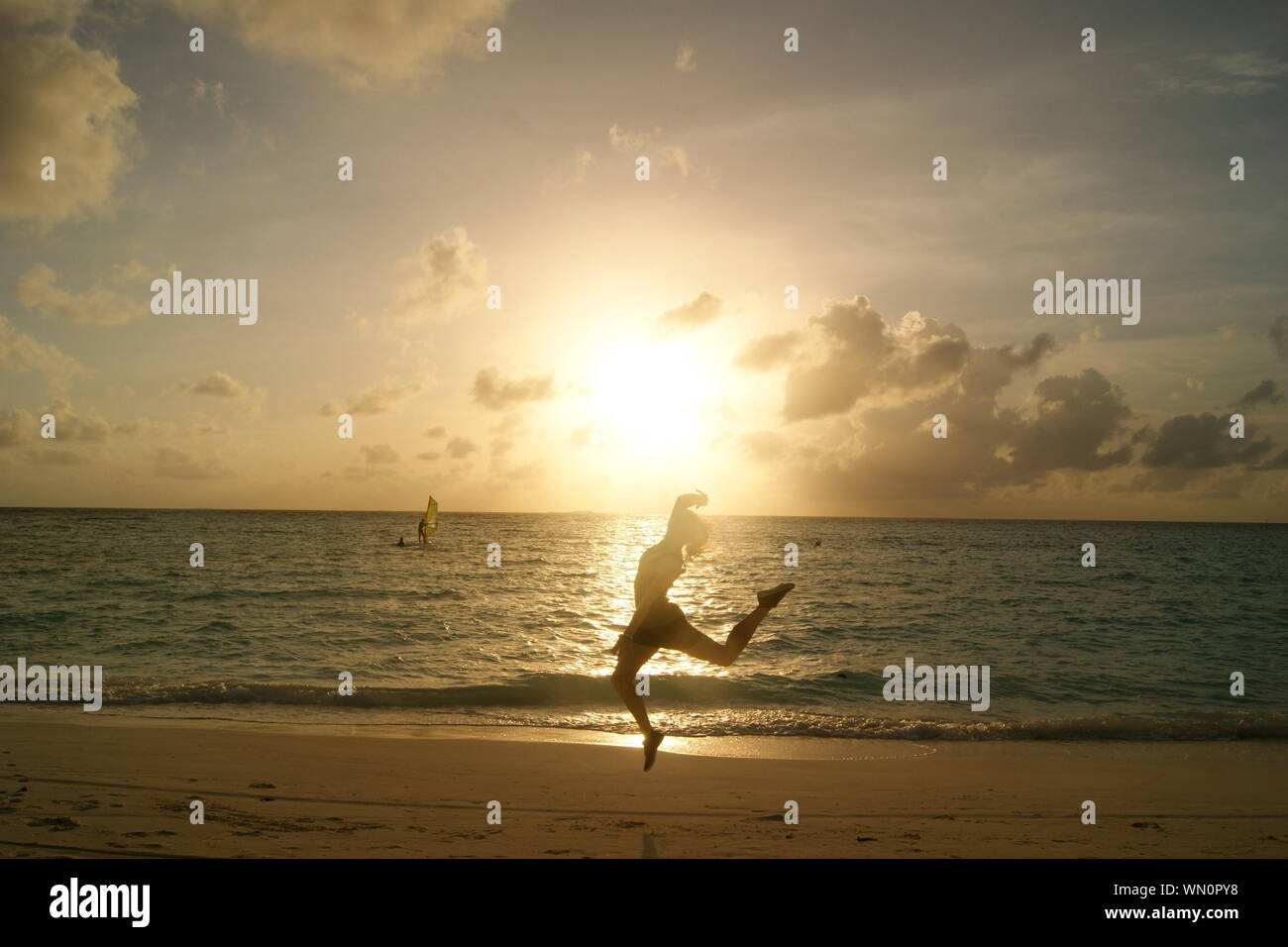 Woman Jumping On Sand At Beach Stock Photo - Alamy