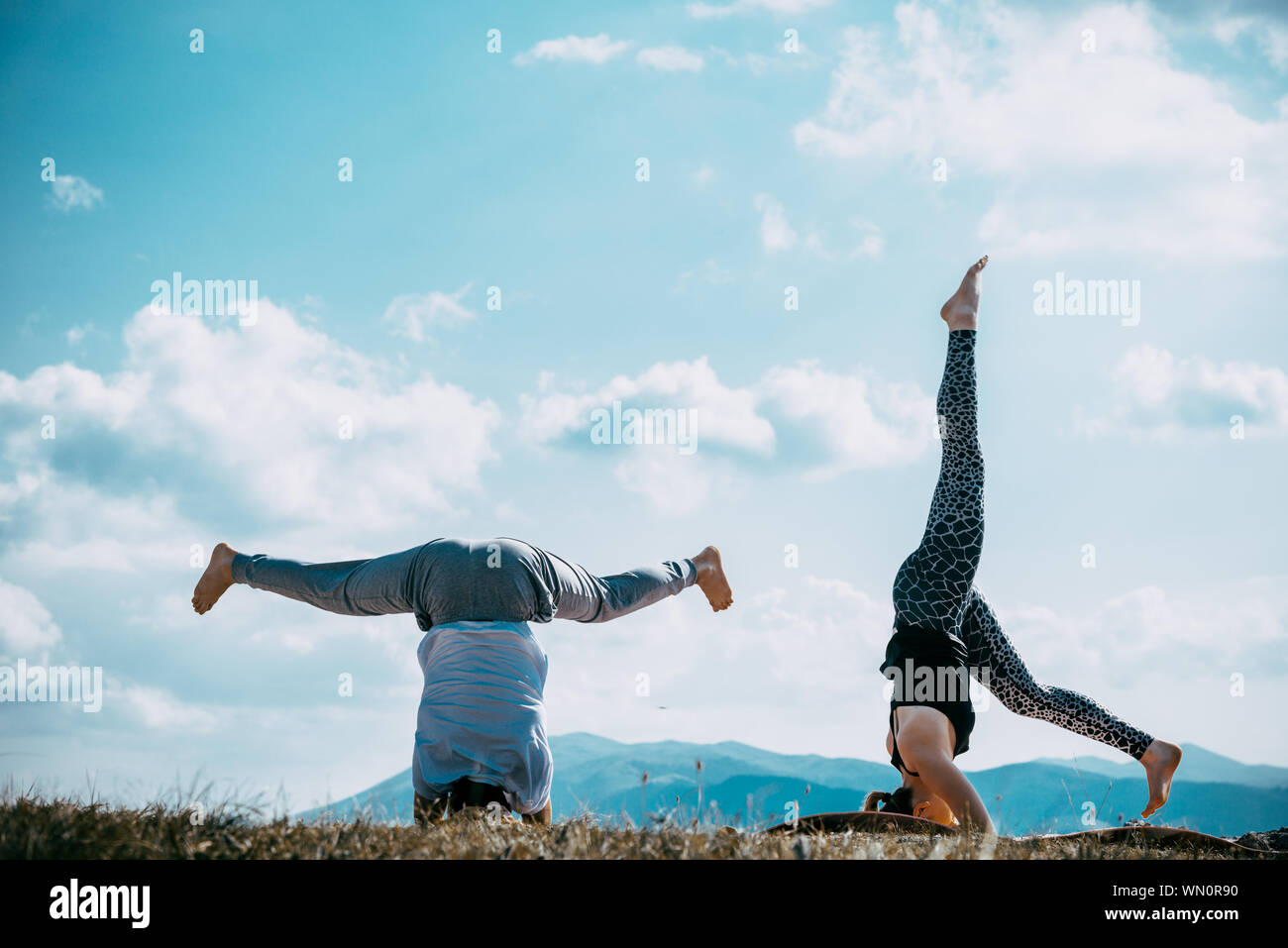 Balance your life. Young couple meditating together while doing yoga ...