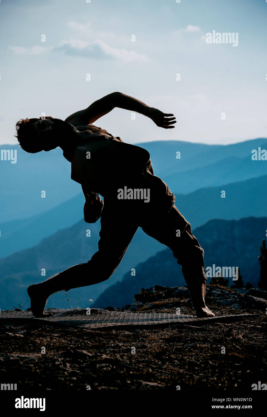 Full body funky looking Caucasian man hip hop dancer dancing on peak ...