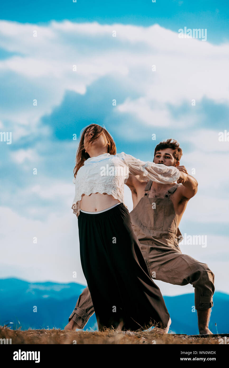Romantic couple dancing and smiling outside at the mountain peak Stock ...