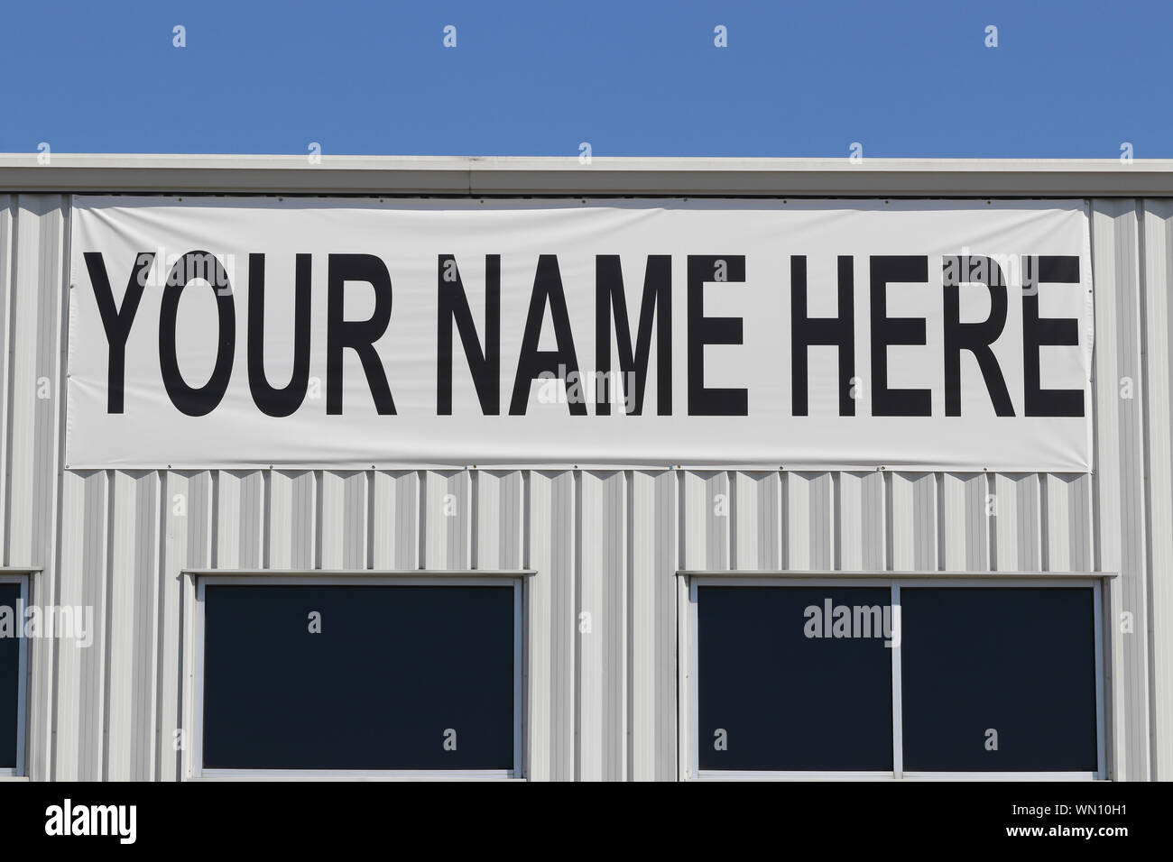 Your Name Here banner on the exterior of a vacant building for lease or ...