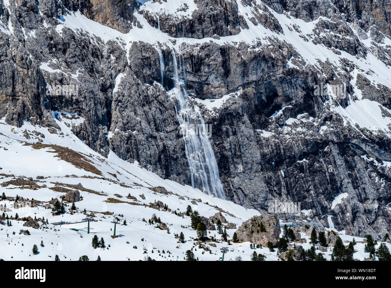 Snow falling down mountain cliff in Dolomites, Italy Stock Photo - Alamy