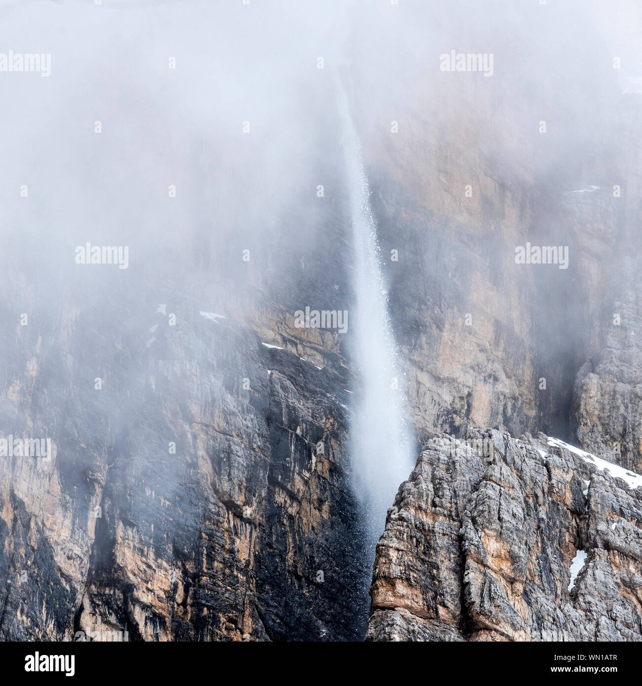 Snow falling down cliff in Dolomites, Italy Stock Photo - Alamy
