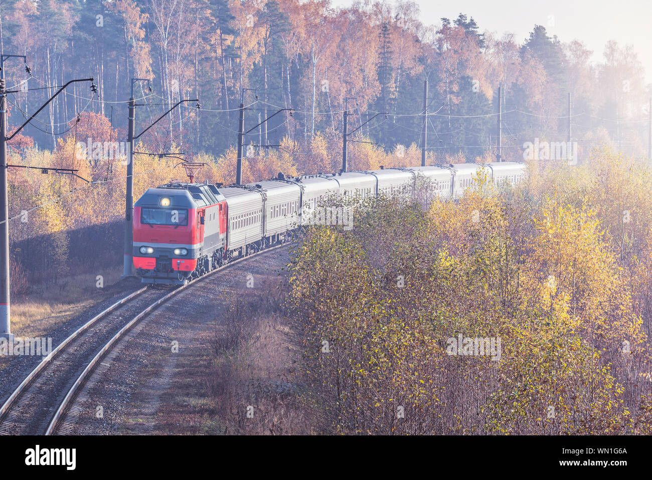 Passenger train approaches to the station Stock Photo - Alamy