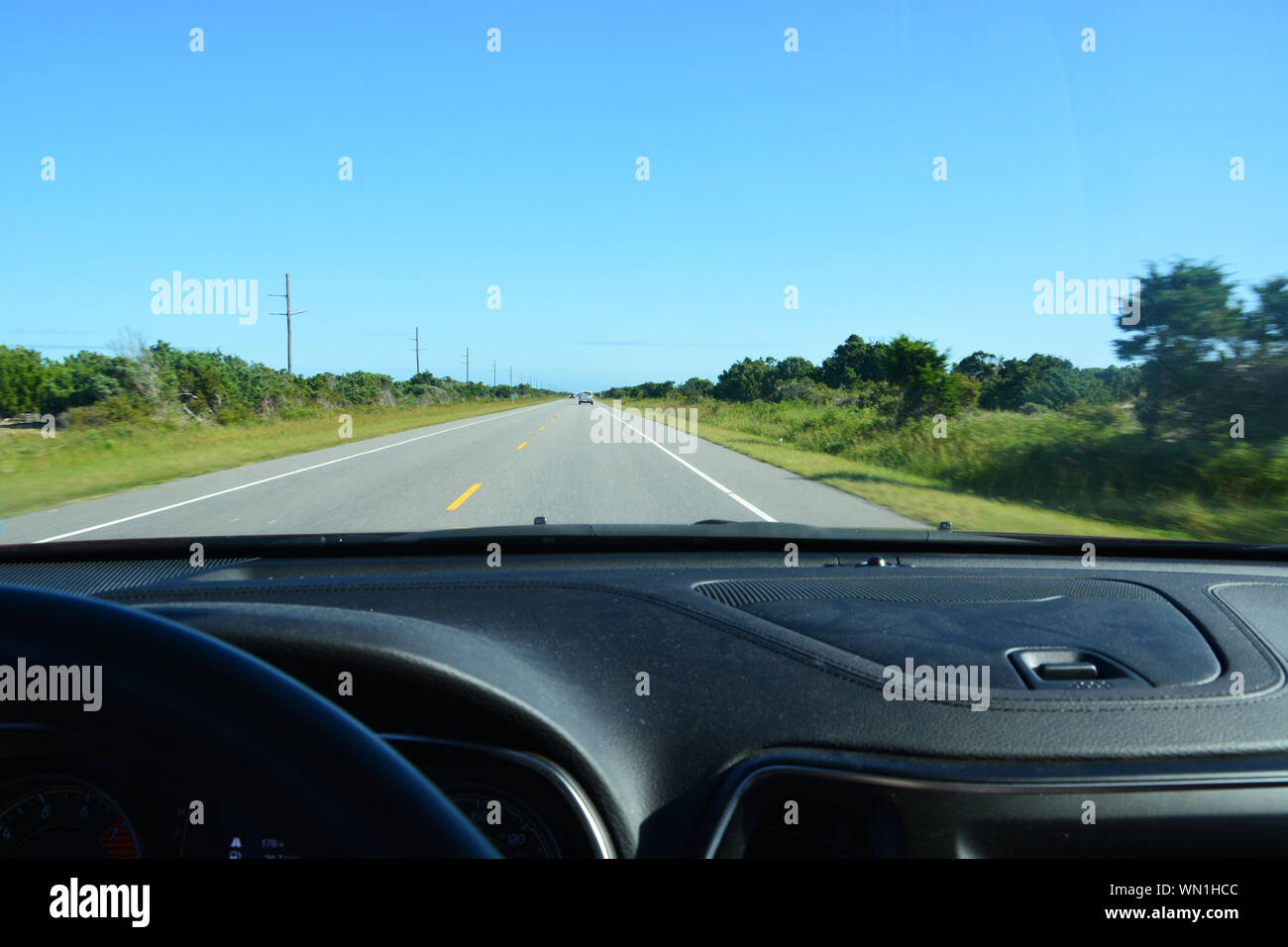 Looking out the front windshield of a car traveling down NC-12 on the ...