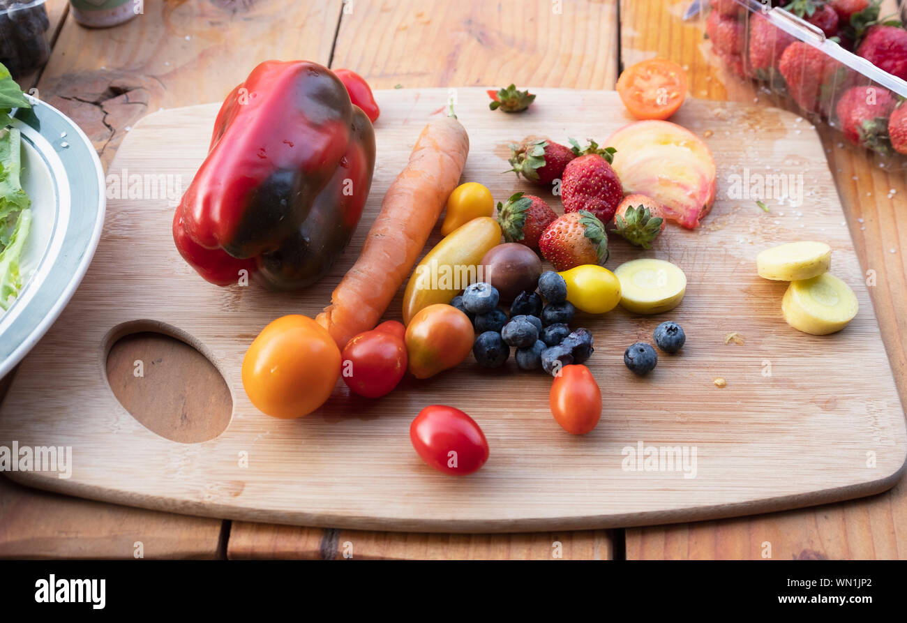 Fruit and vegetables on cutting board Stock Photo - Alamy