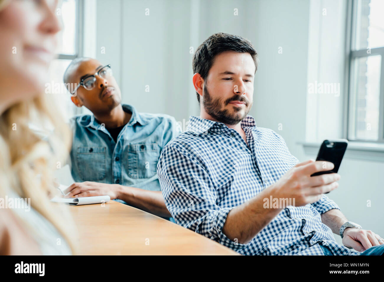 Business man using phone during meeting hi-res stock photography and ...
