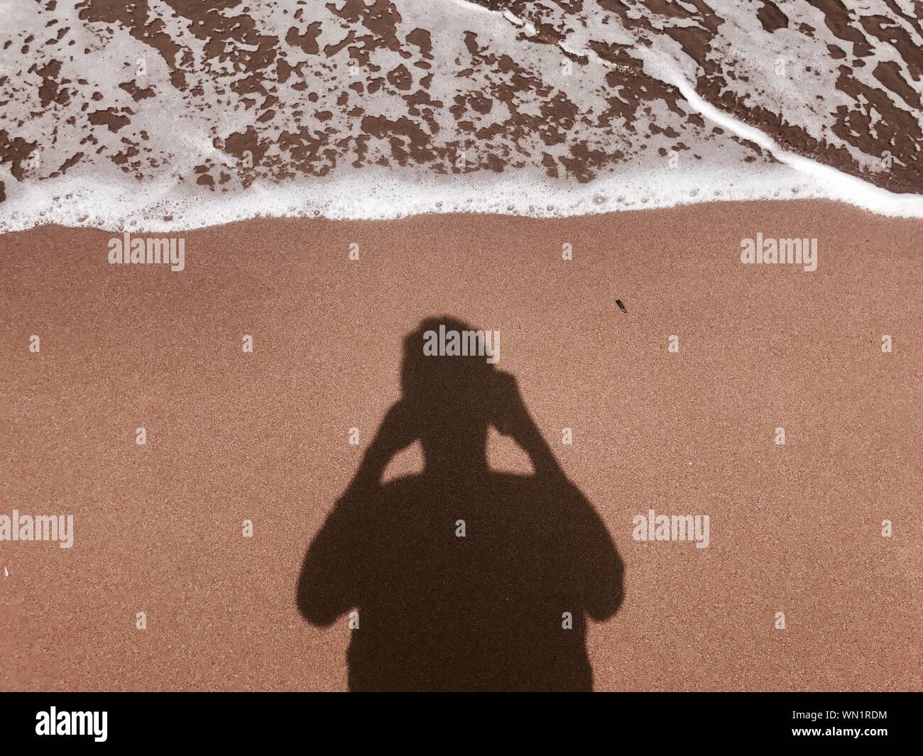 Shadow Of Man On Sand At Beach Stock Photo - Alamy