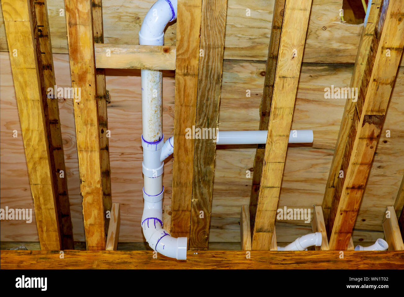 New home under construction interior drain pipes plumbing inside a ...