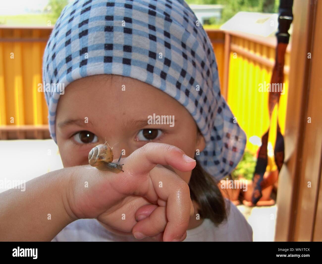 Close-up Portrait Of Girl With Snail Stock Photo - Alamy