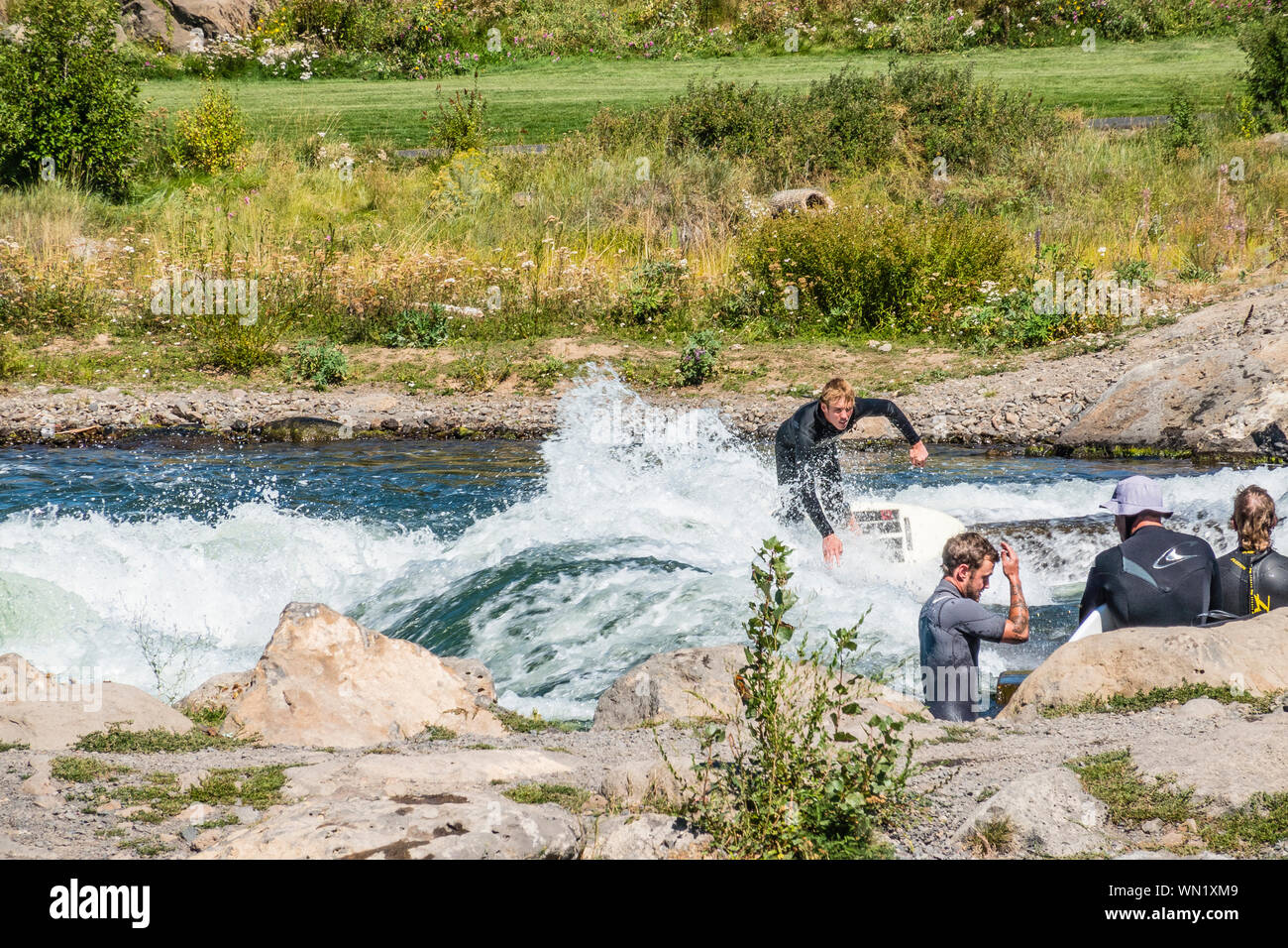 River surfing on the Deschutes River in Bend, Oregon. River surfing is ...