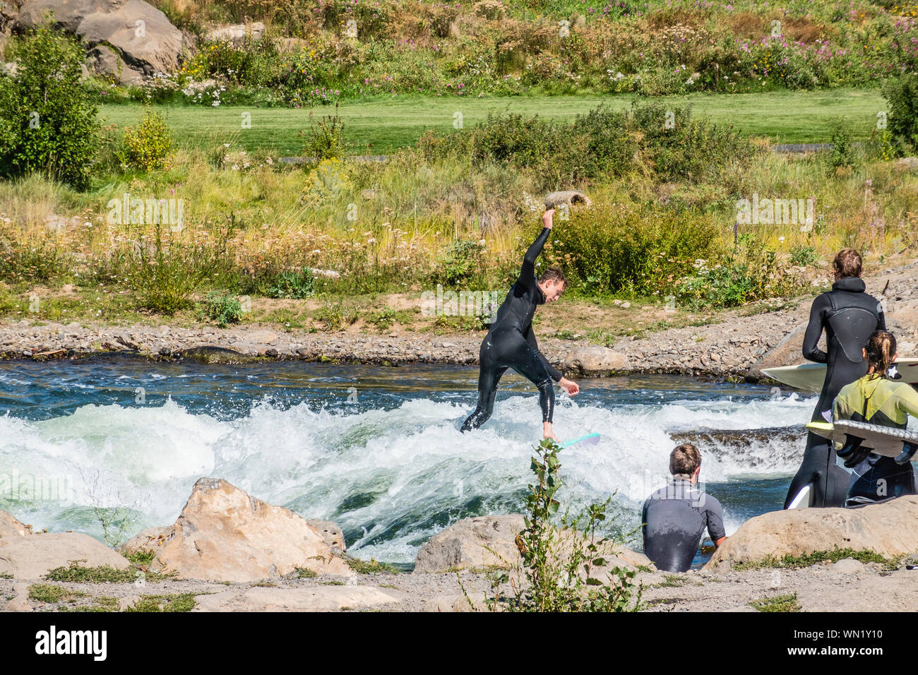 River surfing on the Deschutes River in Bend, Oregon. River surfing is ...