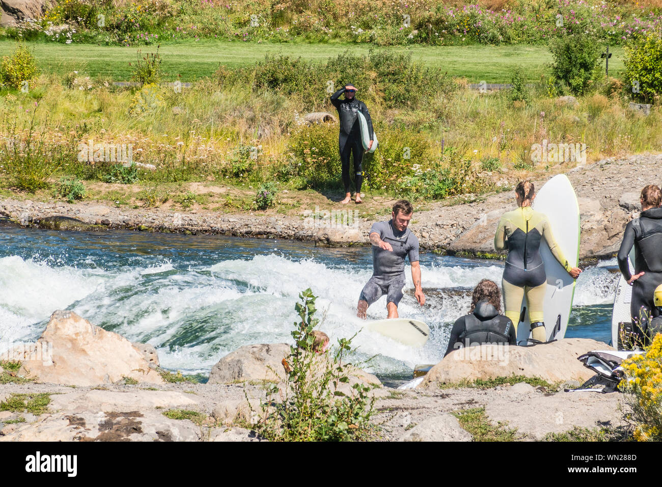 River surfing on the Deschutes River in Bend, Oregon. River surfing is ...