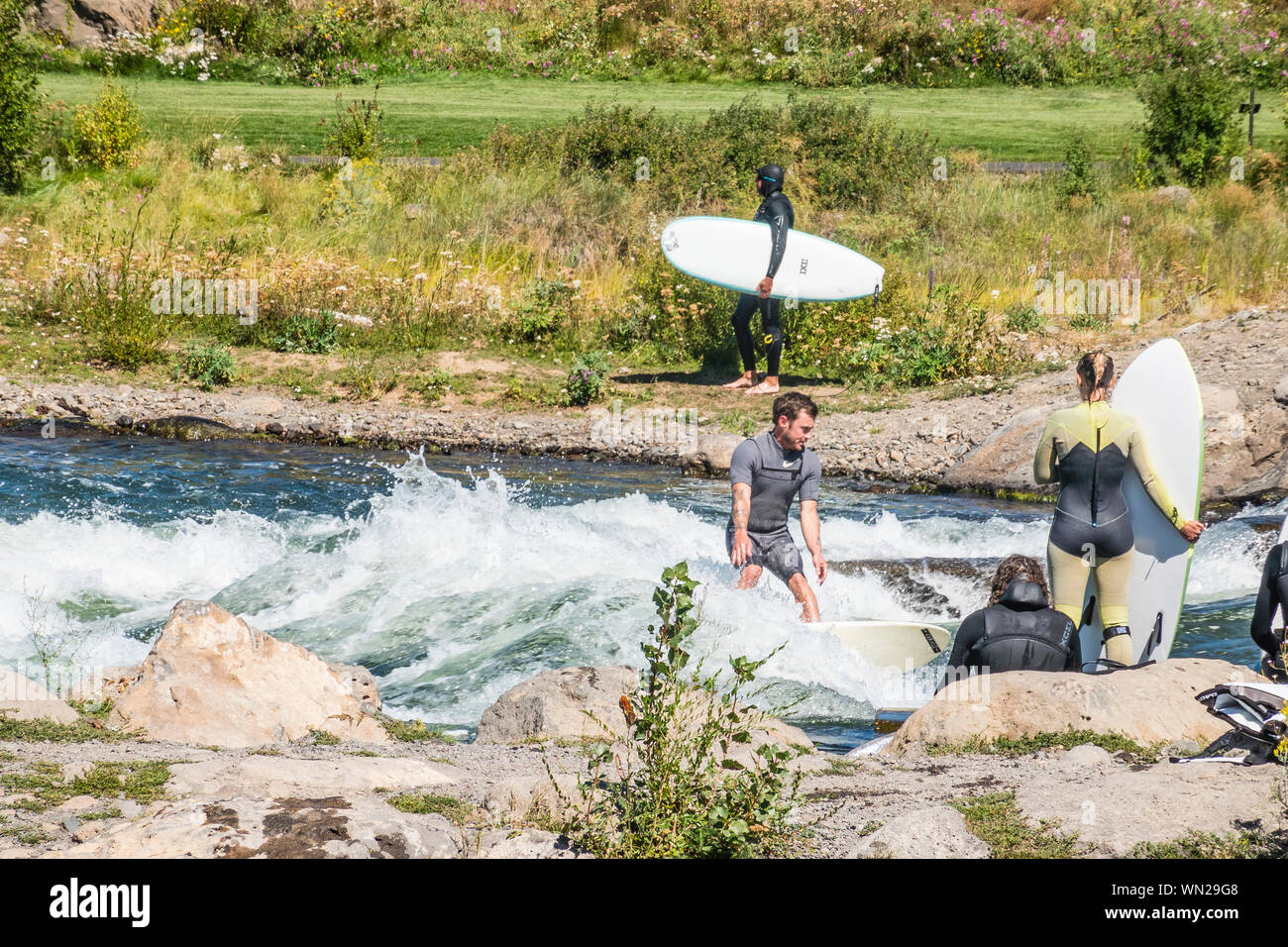 River surfing on the Deschutes River in Bend, Oregon. River surfing is ...