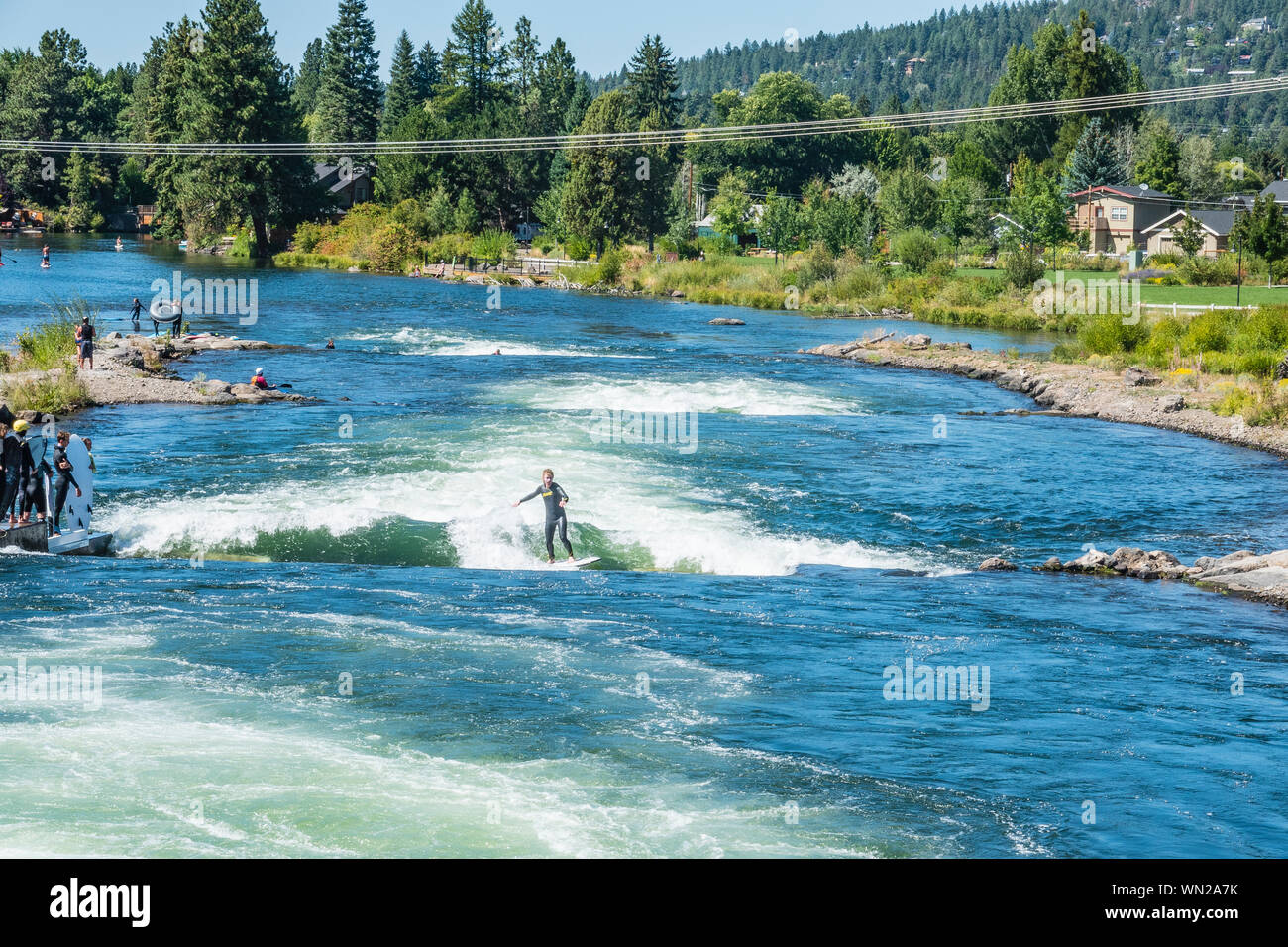River surfing on the Deschutes River in Bend, Oregon. River surfing is ...