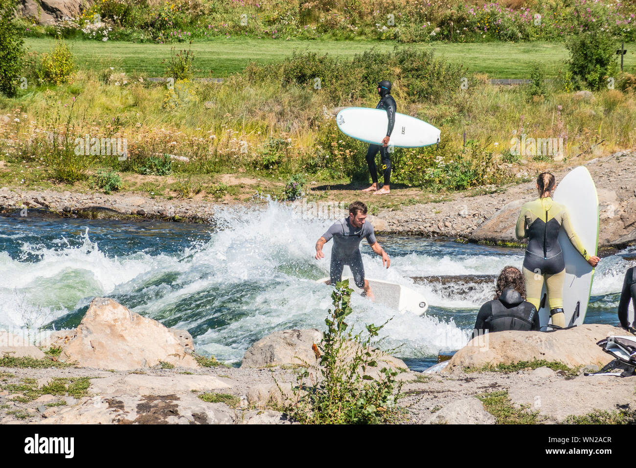 River surfing on the Deschutes River in Bend, Oregon. River surfing is ...