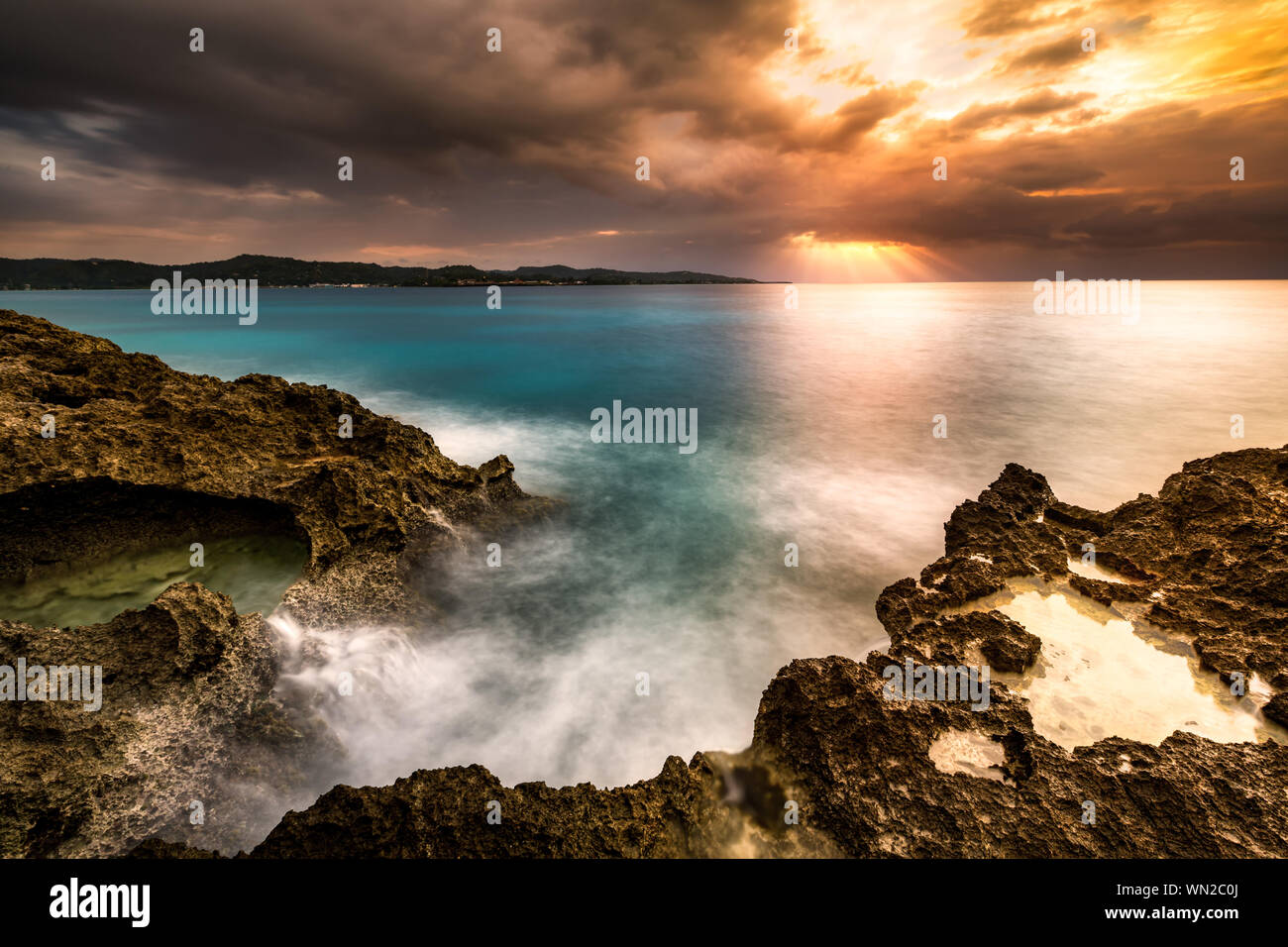 Sunset over rocky coastline hi-res stock photography and images - Alamy