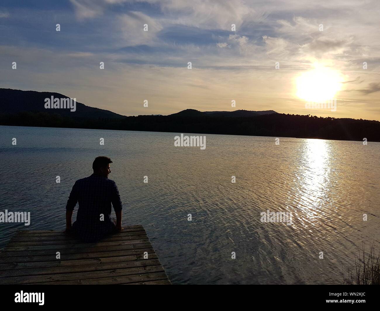Man sitting jetty looking lake hi-res stock photography and images - Alamy