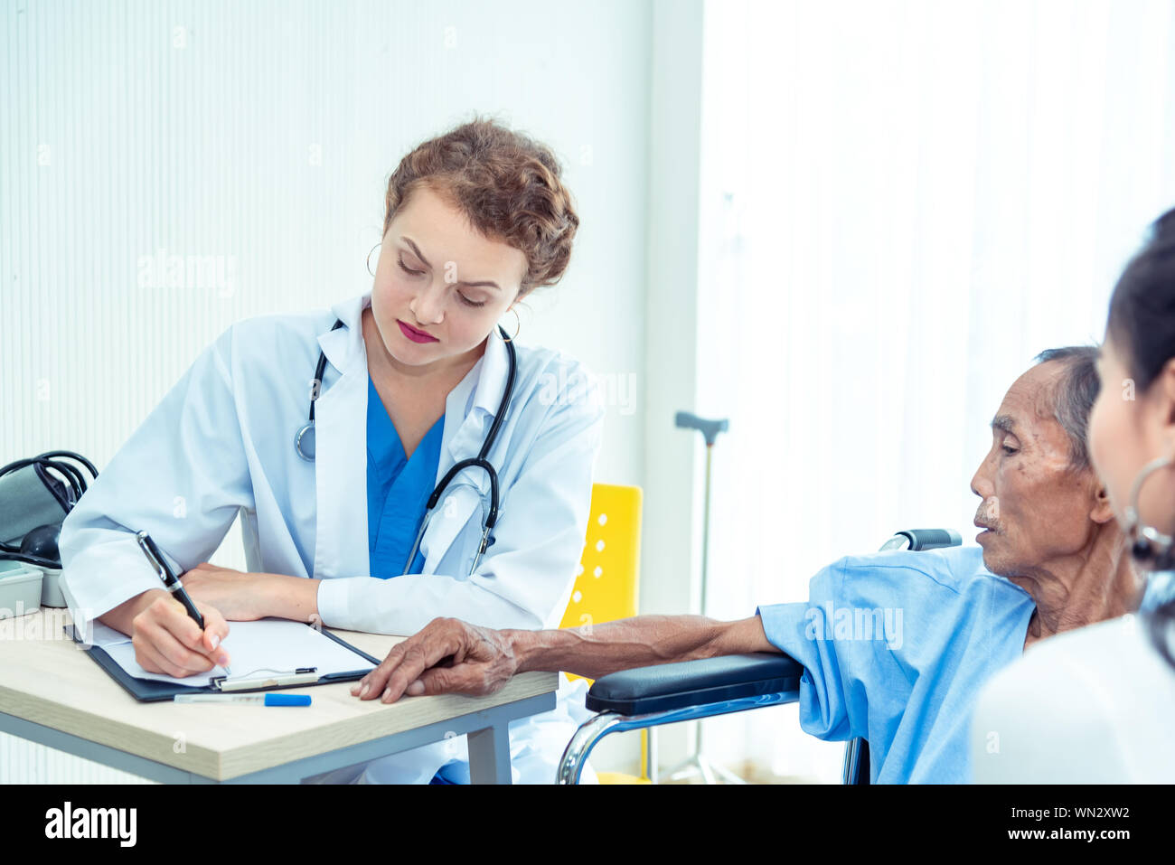 Young professional female doctor helping hands ,explaining diagnosis to ...