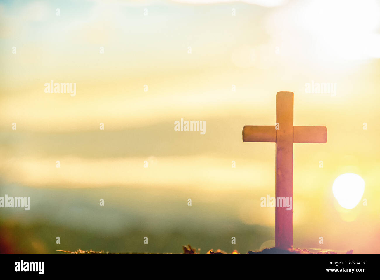 Wooden cross at sunrise in morning time with holy and light background ...