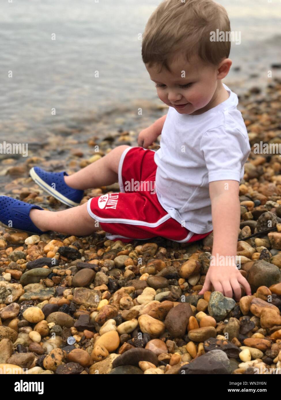 Boy sitting on stone hi-res stock photography and images - Alamy