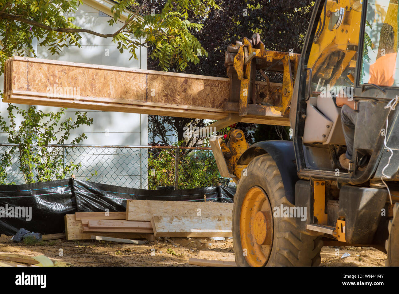 A construction worker installing silent floor forklift stacker loader ...