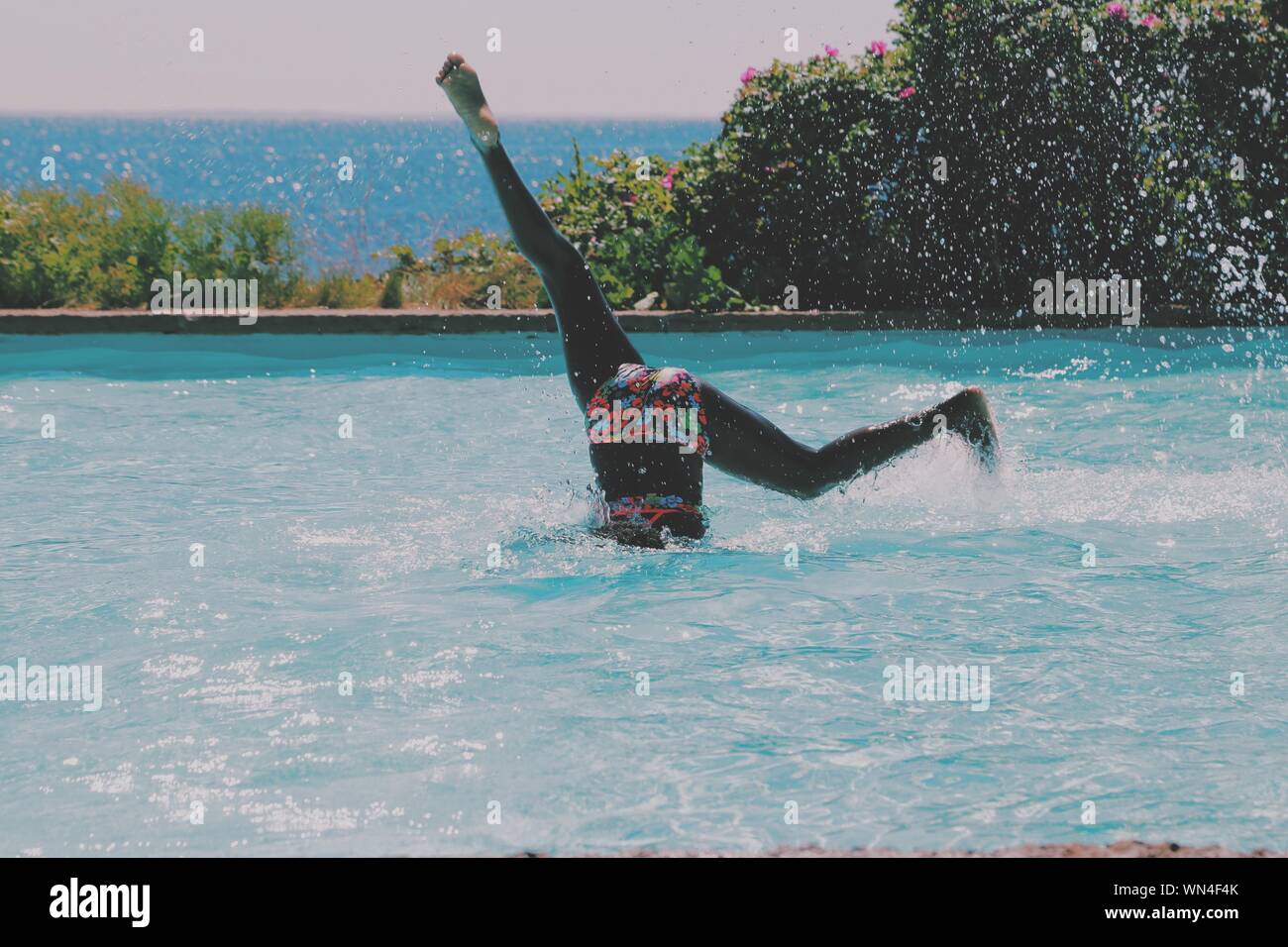 Woman diving upside down in hi-res stock photography and images - Alamy