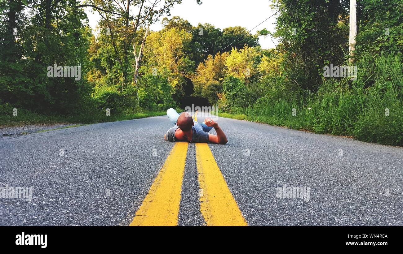 Man lying down road hi-res stock photography and images - Alamy