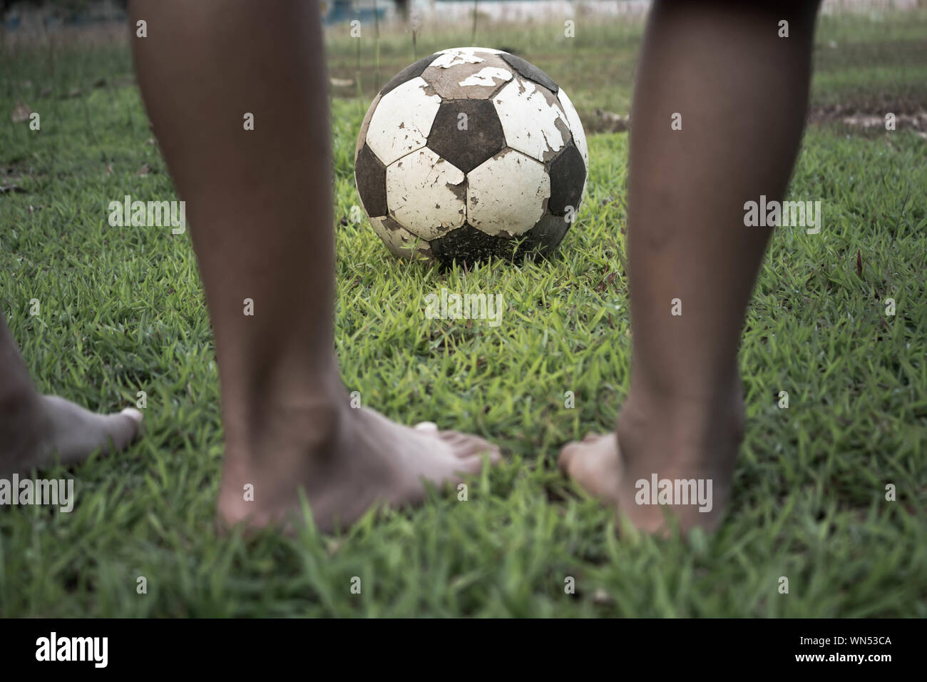 Boys playing soccer barefoot hi-res stock photography and images - Alamy