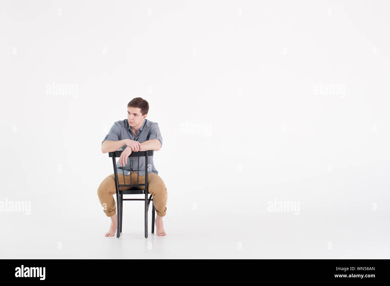 Man sitting chair studio shot hi-res stock photography and images - Alamy