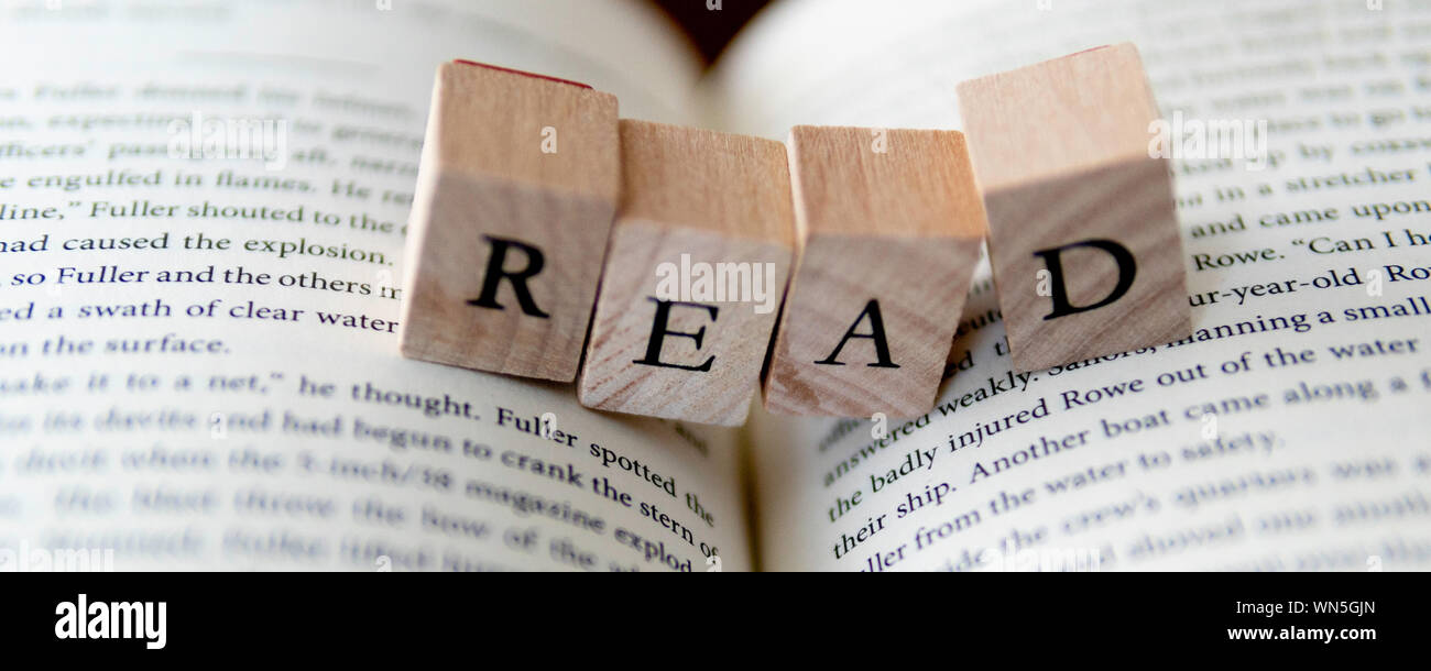 Read in Block Letter on an open book Stock Photo - Alamy