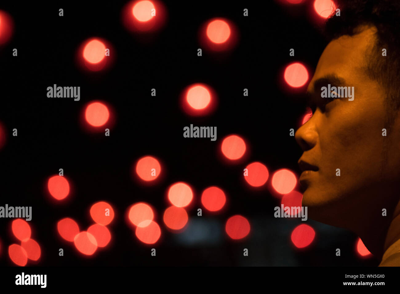 Face young man glowing light hi-res stock photography and images - Alamy