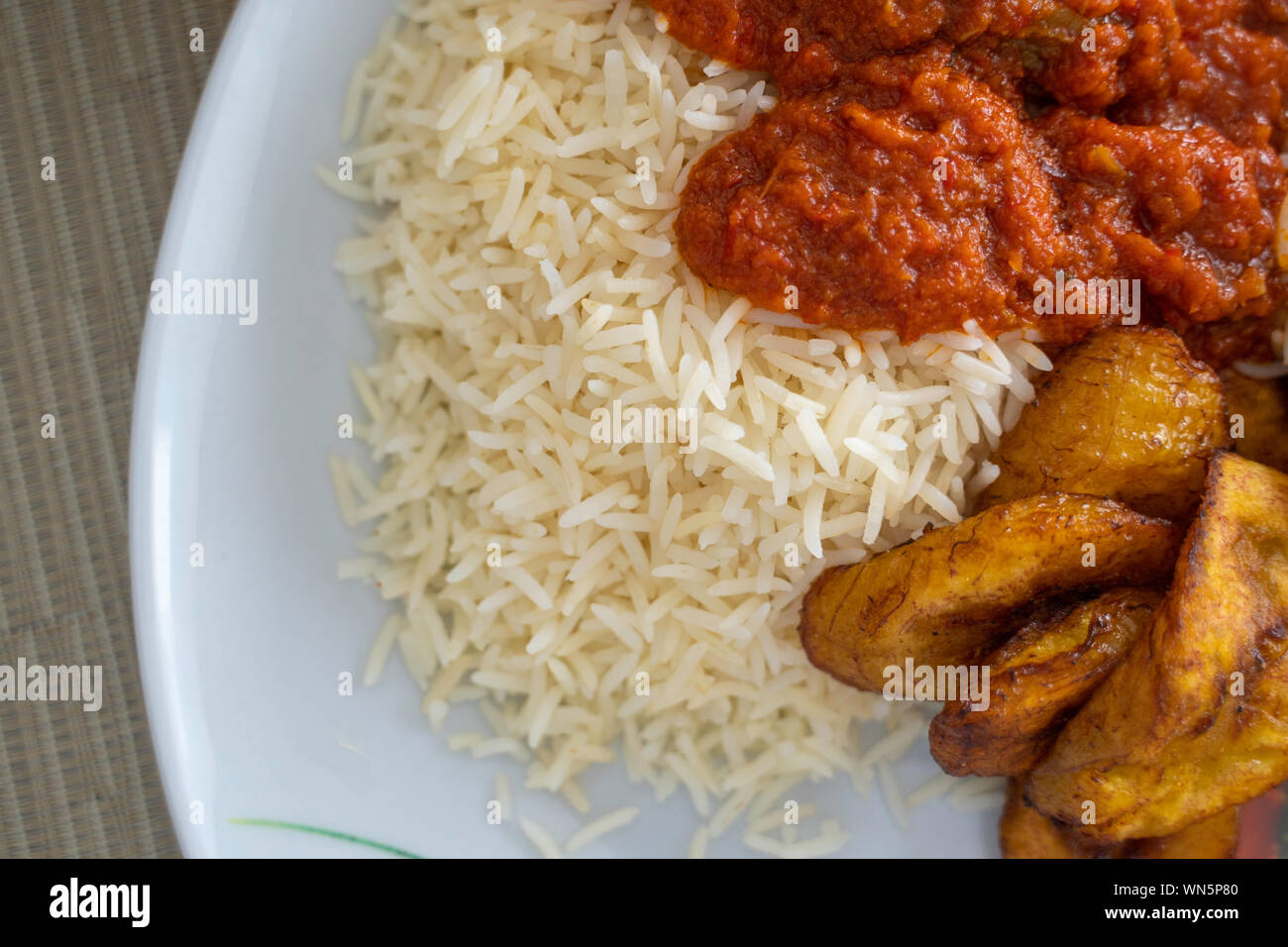 Nigerian Rice and Plantain - Dodo - with spicy Tomato Pepper Stew Stock ...