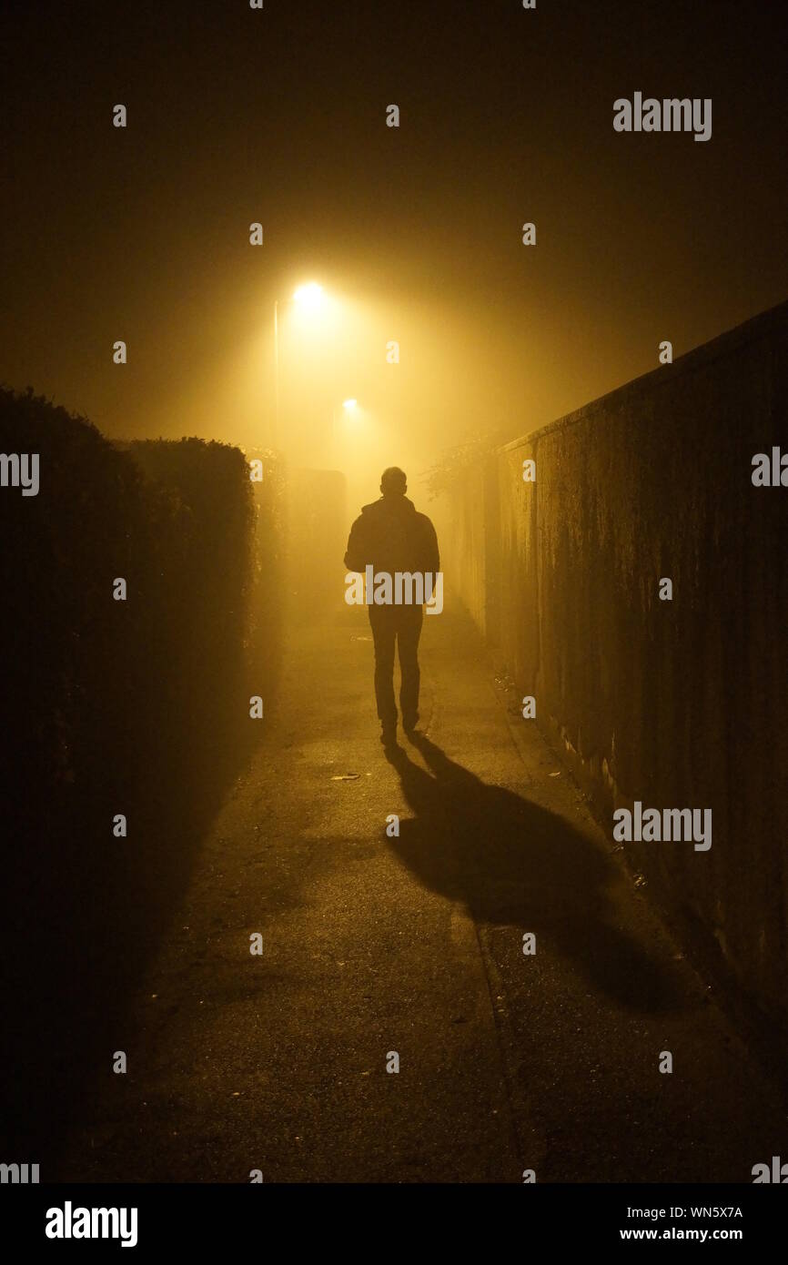 Man walking along wall hi-res stock photography and images - Alamy