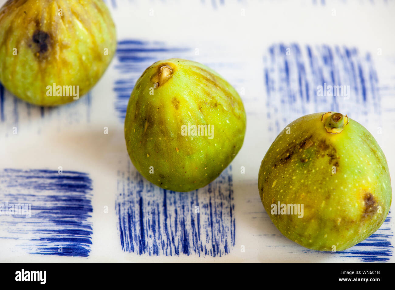 Three figs a isolated on white background Stock Photo - Alamy