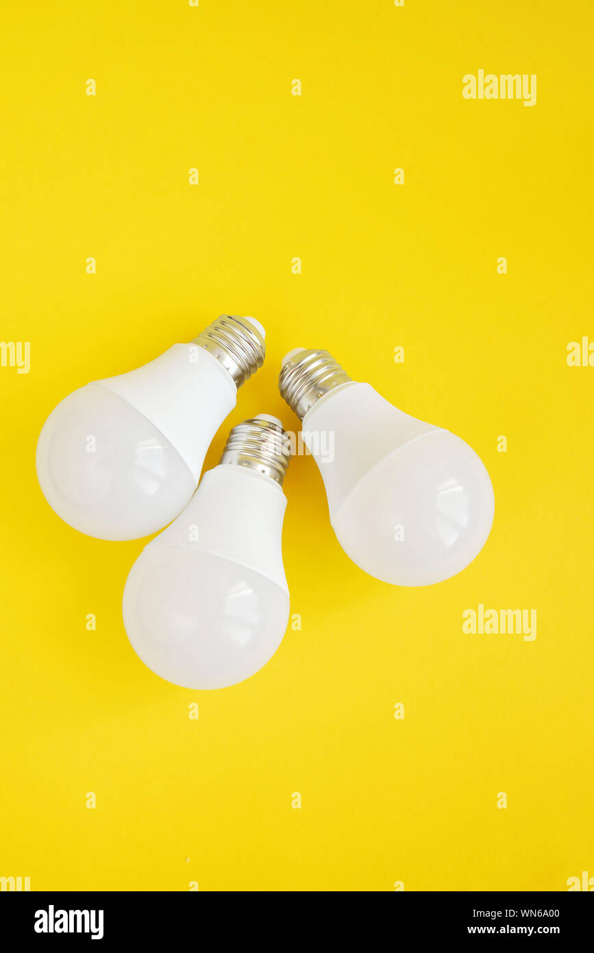 Three LED light bulbs on yellow background. energy saving concept Stock ...