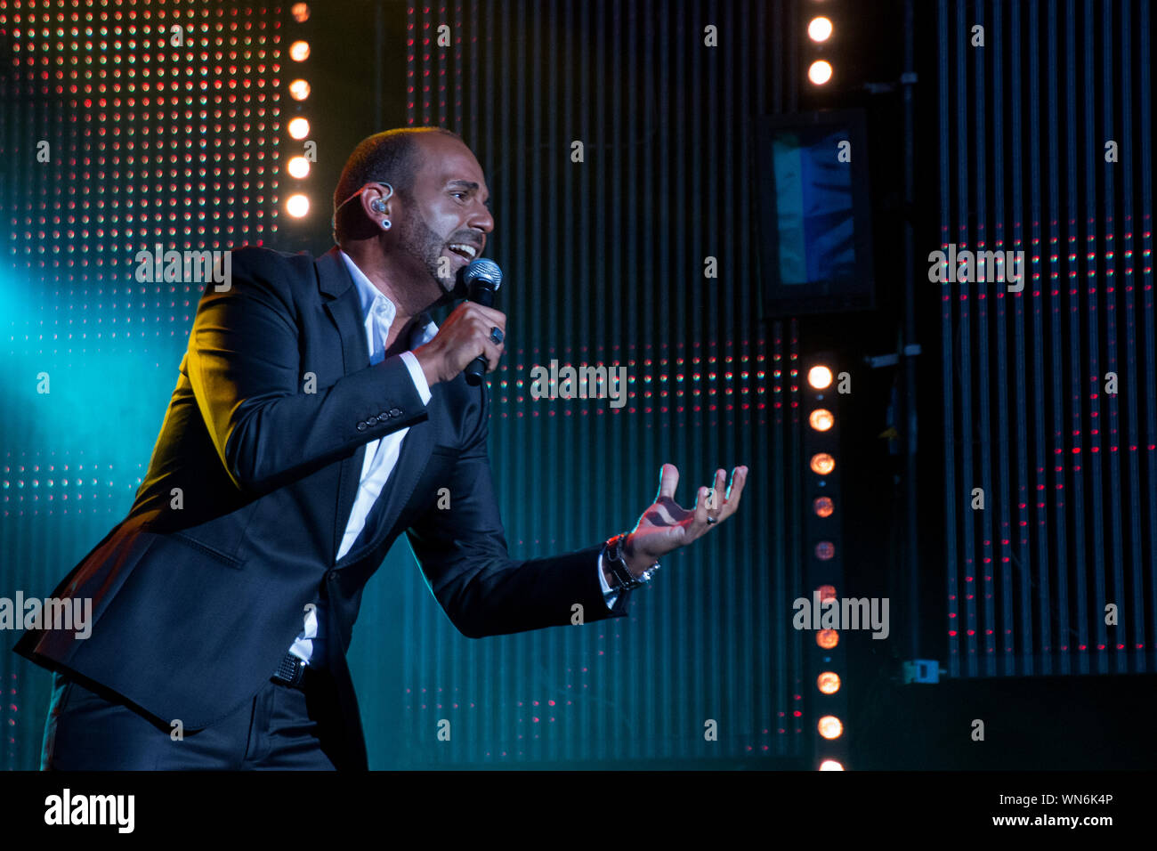 Performance standing looking away singing microphone hi-res stock ...