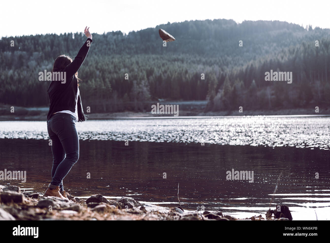 Throwing rock in water hi-res stock photography and images - Alamy