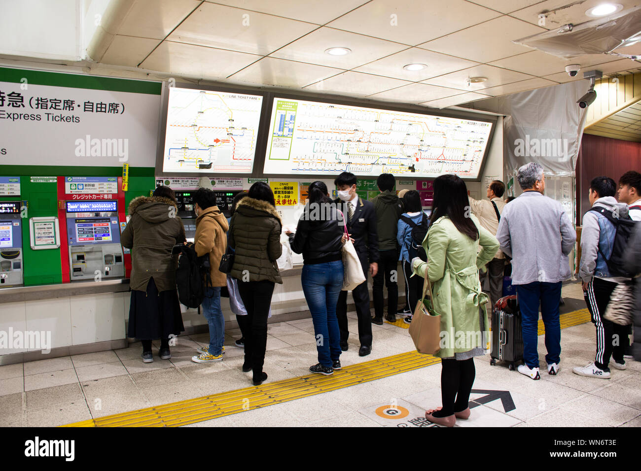 Japanese people and foreign travelers passenger wait and stand in queue ...