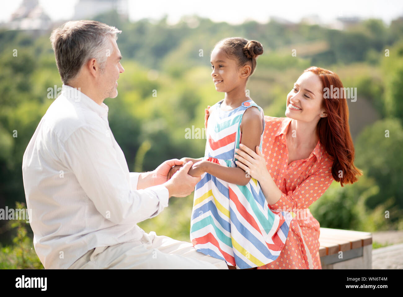 Cute girl feeling excited while meeting her foster father Stock Photo ...