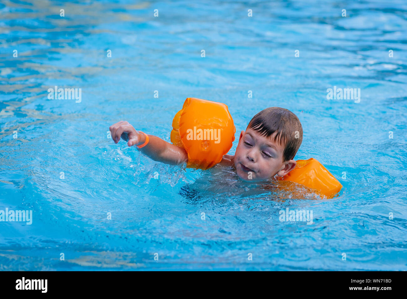 Boy Playing In Swimming Pool Stock Photo - Alamy